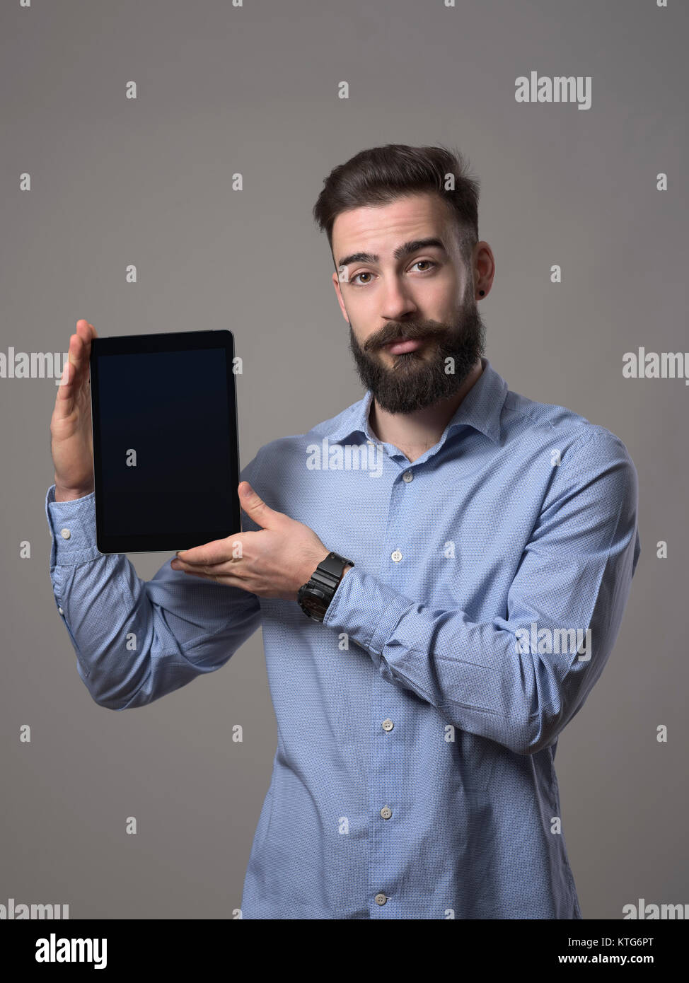 Handsome young bearded programmer advertising application software on ...