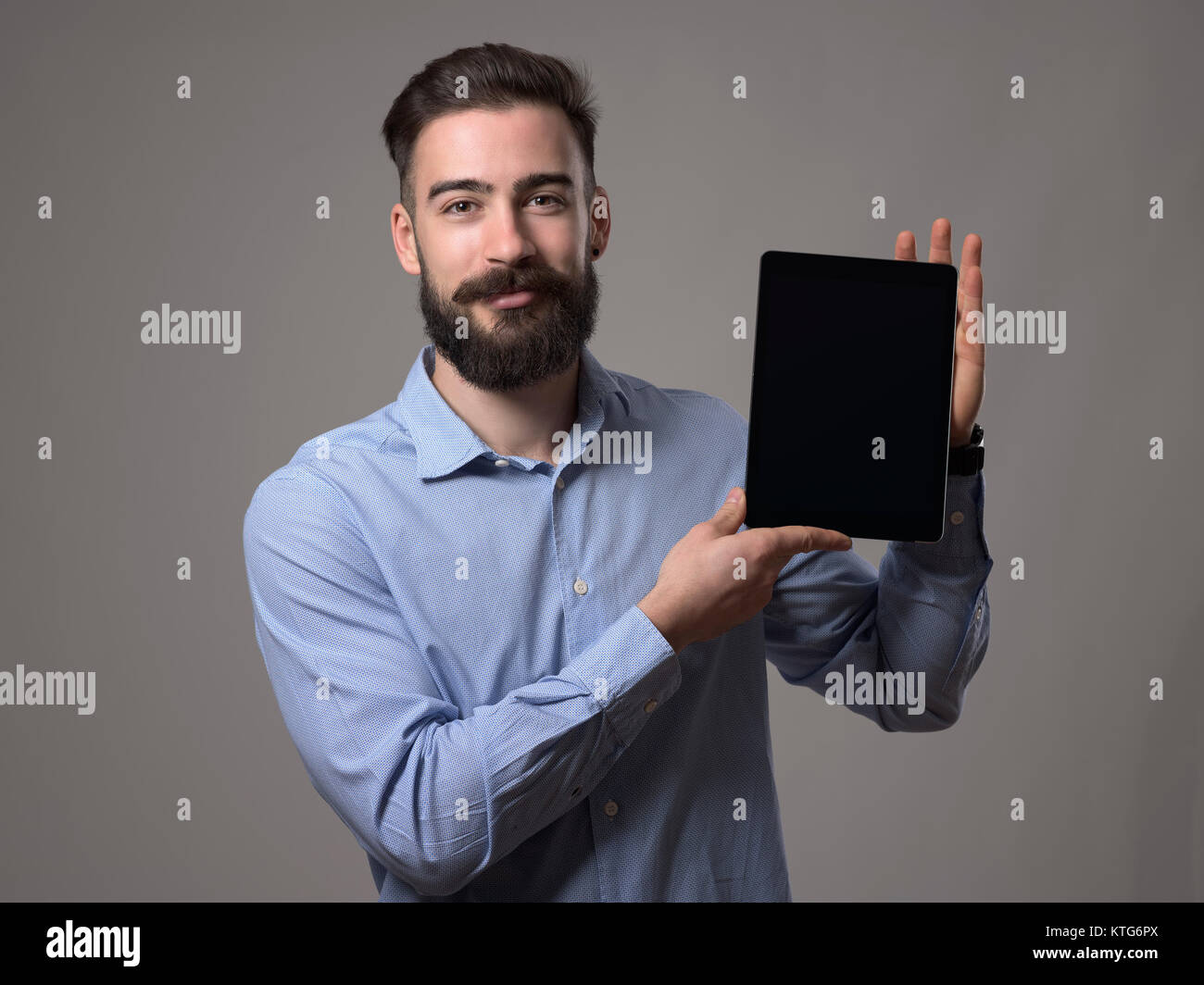 Happy smiling young bearded business person or programmer showing ...