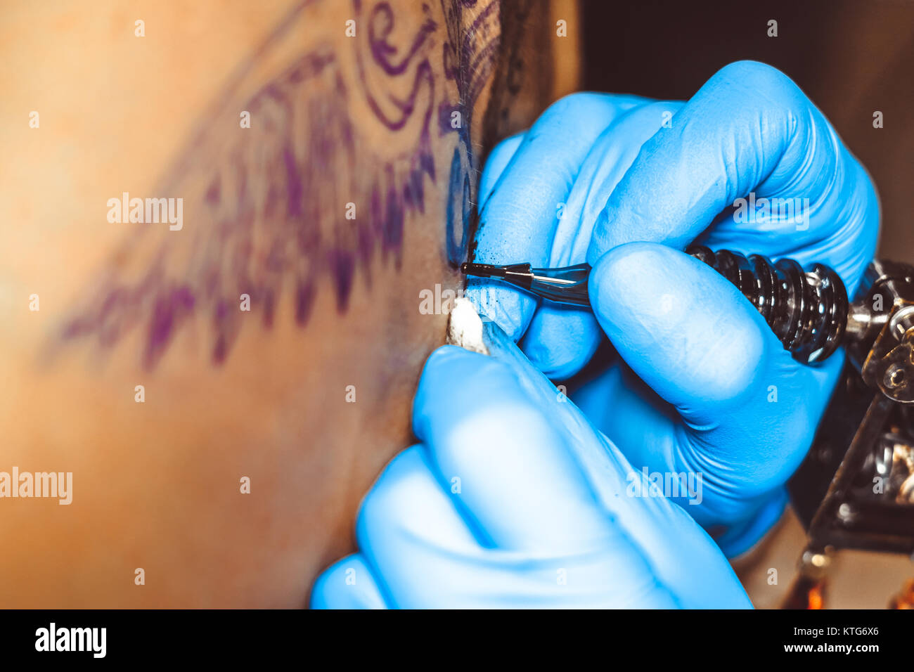 tattooer showing process of making a tattoo hands holding a tatoo ...