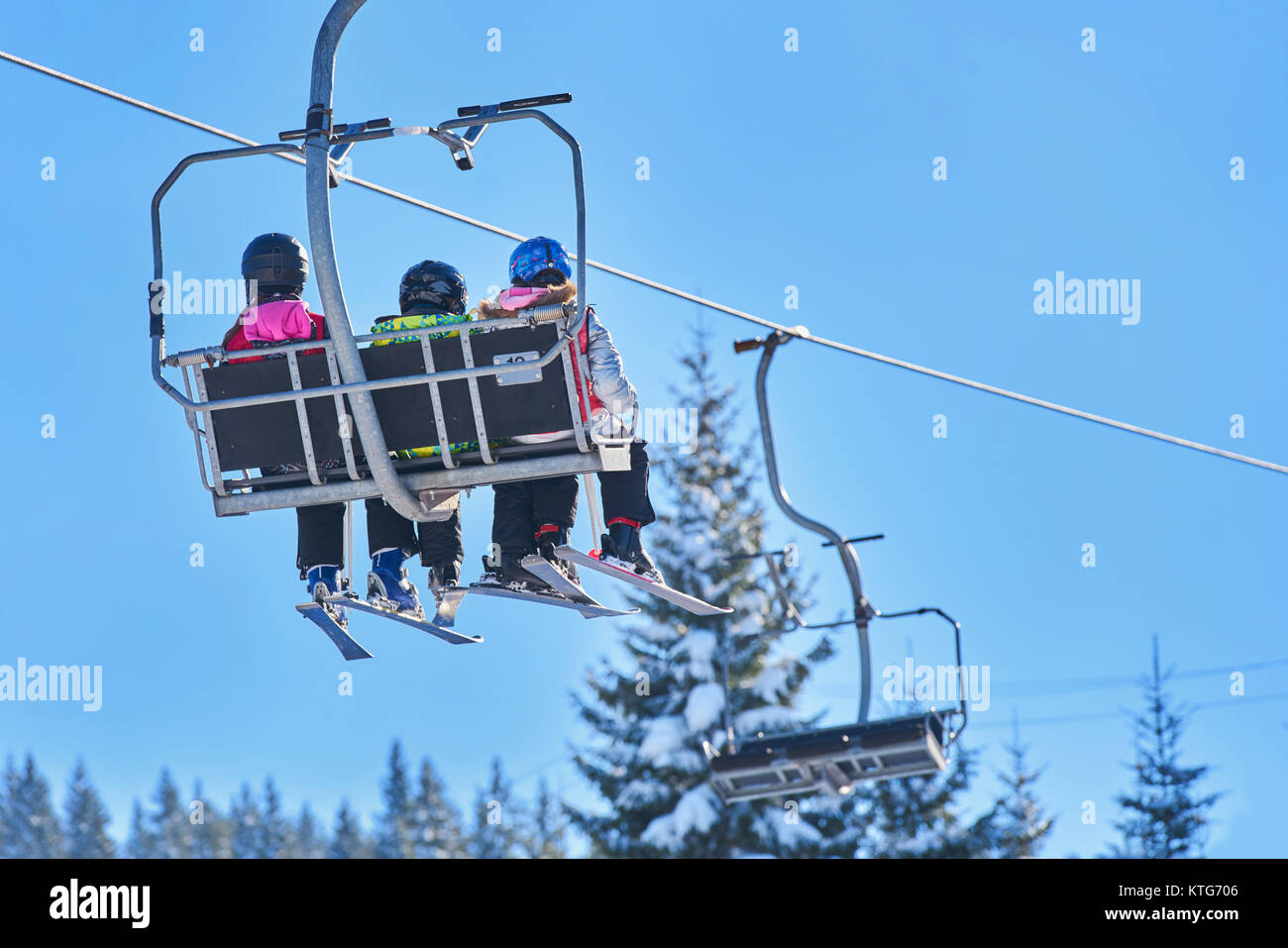 Skiers and snowboarders on a ski lift Stock Photo - Alamy