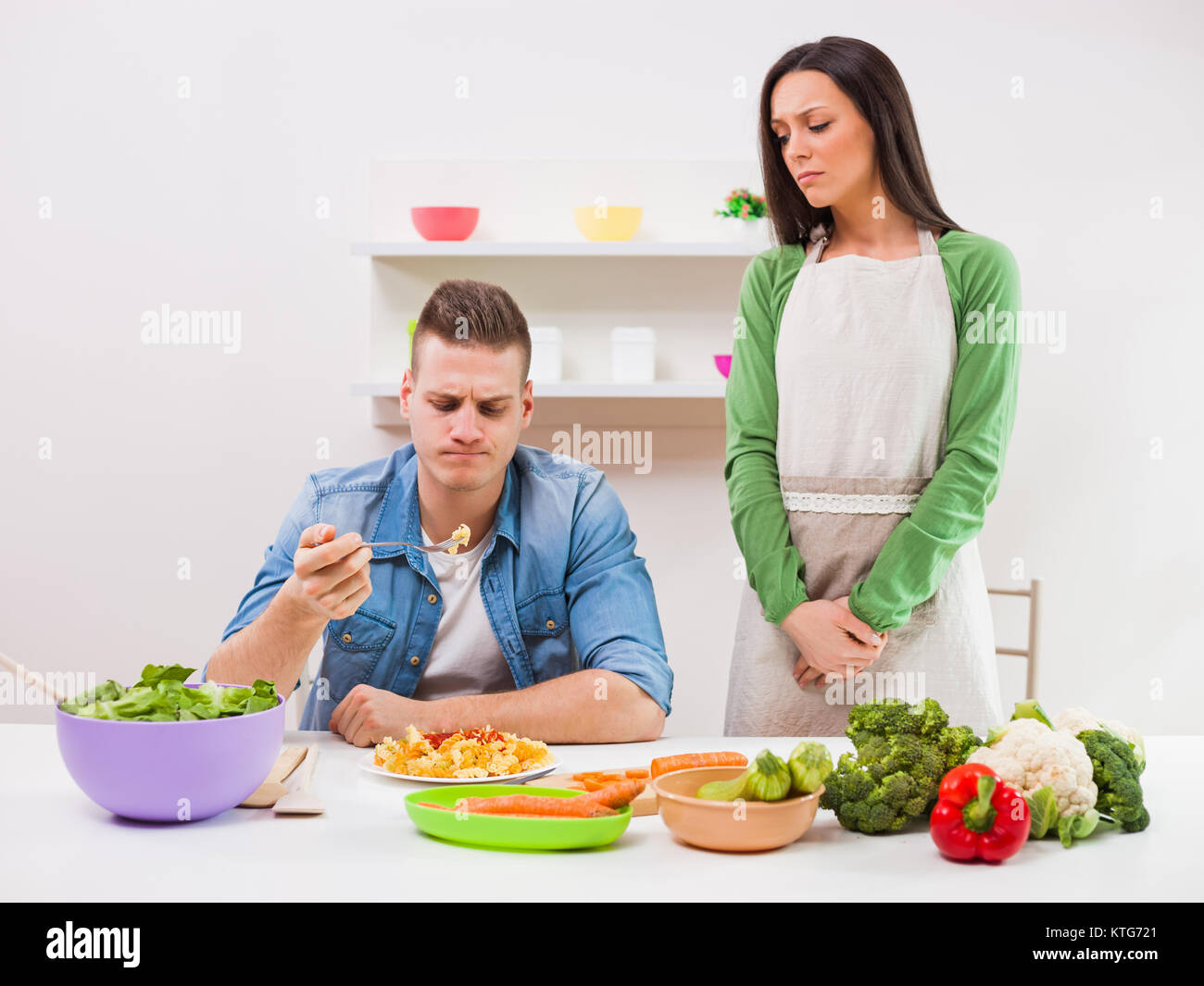 Young couple cooking in their kitchen Stock Photo - Alamy