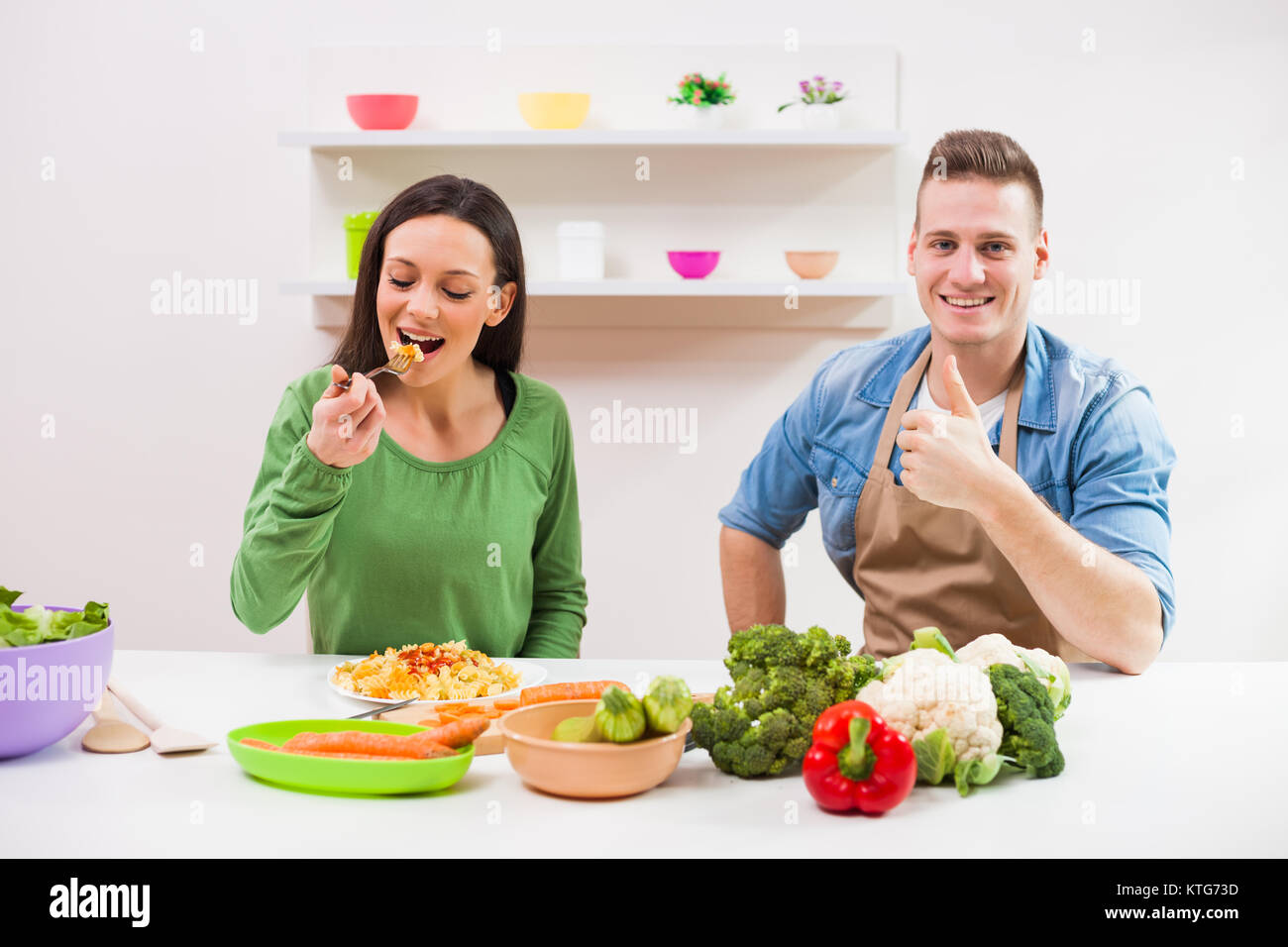 Young couple cooking in their kitchen Stock Photo - Alamy
