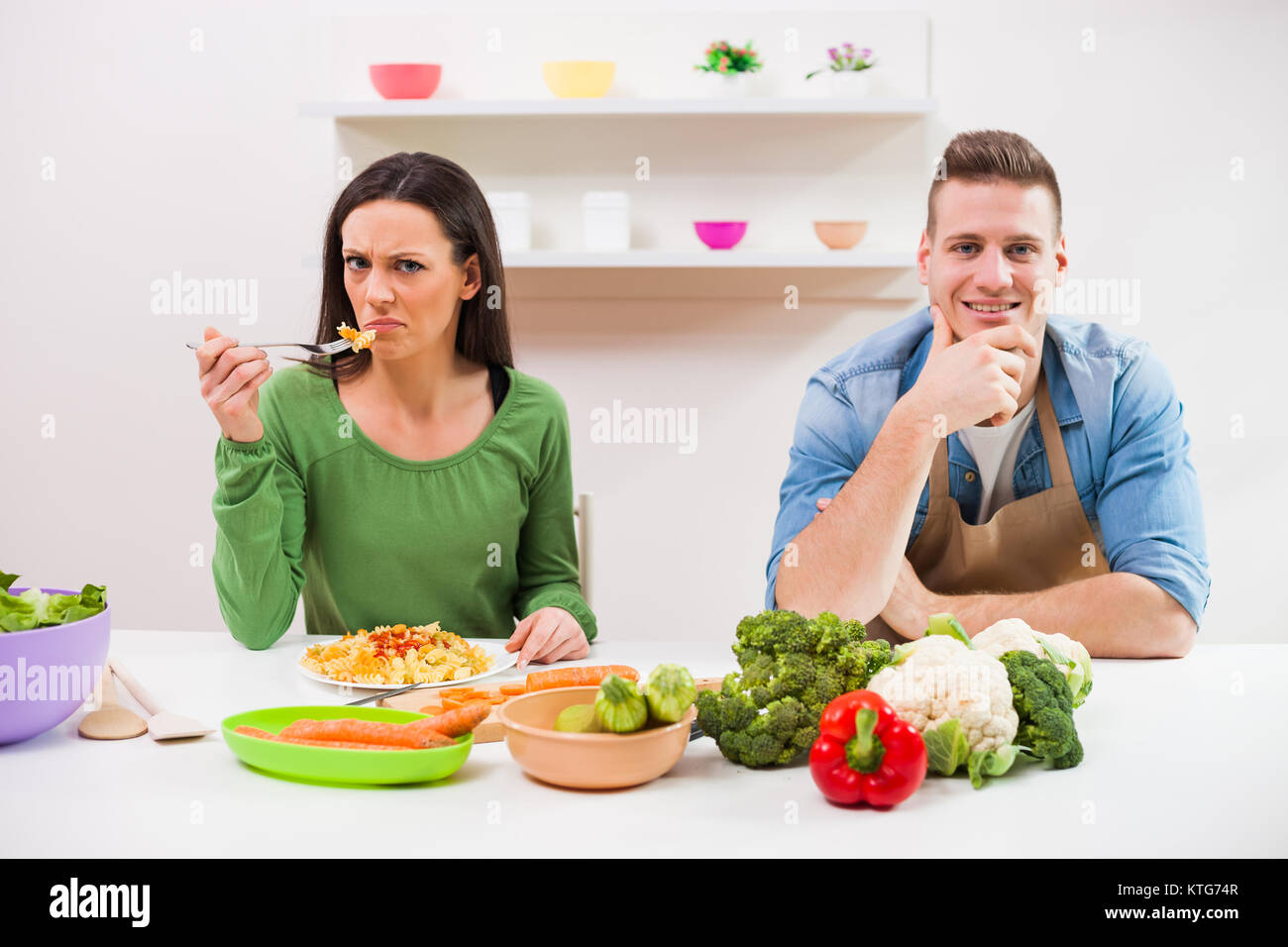 Young couple cooking in their kitchen Stock Photo - Alamy