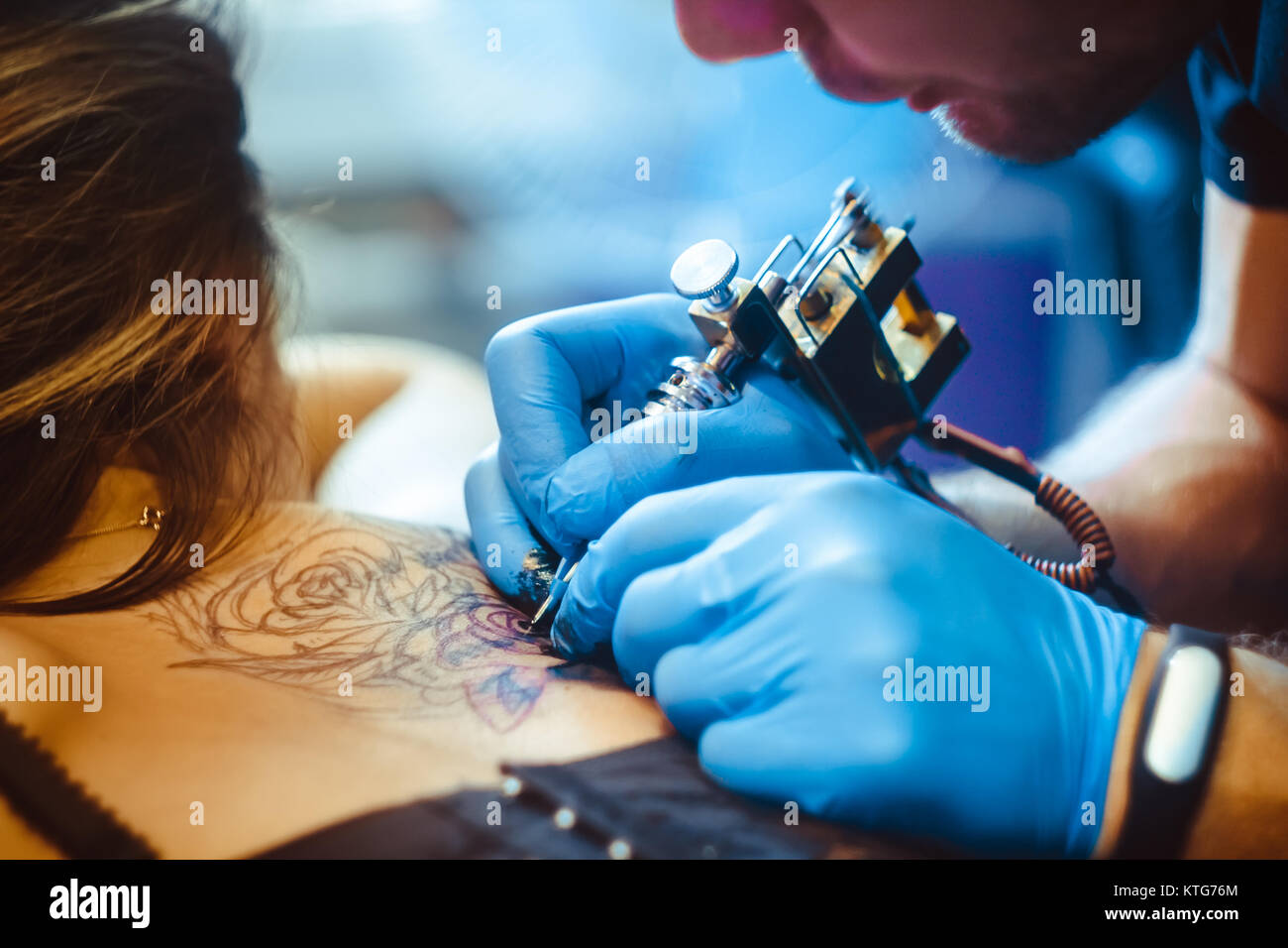 tattooer showing process of making a tattoo, hands holding a tatoo ...