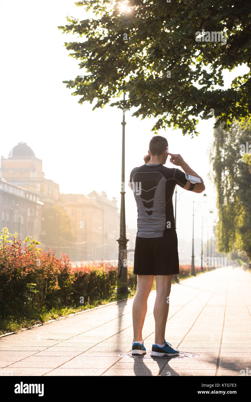 young sporty man jogging at sunny morning in the city Stock Photo - Alamy