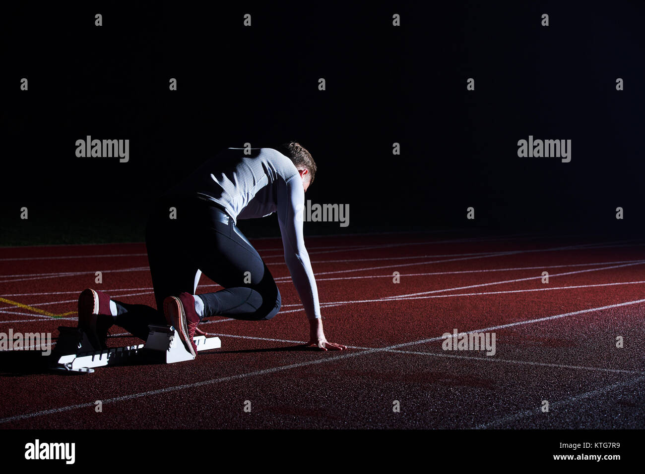 Sport. Sprinter leaving starting blocks on the running track Stock ...
