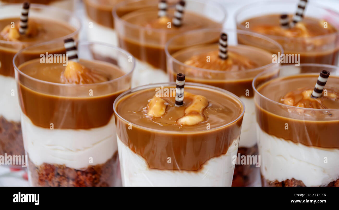 Cups with different colored layers of sweets and nuts Stock Photo - Alamy