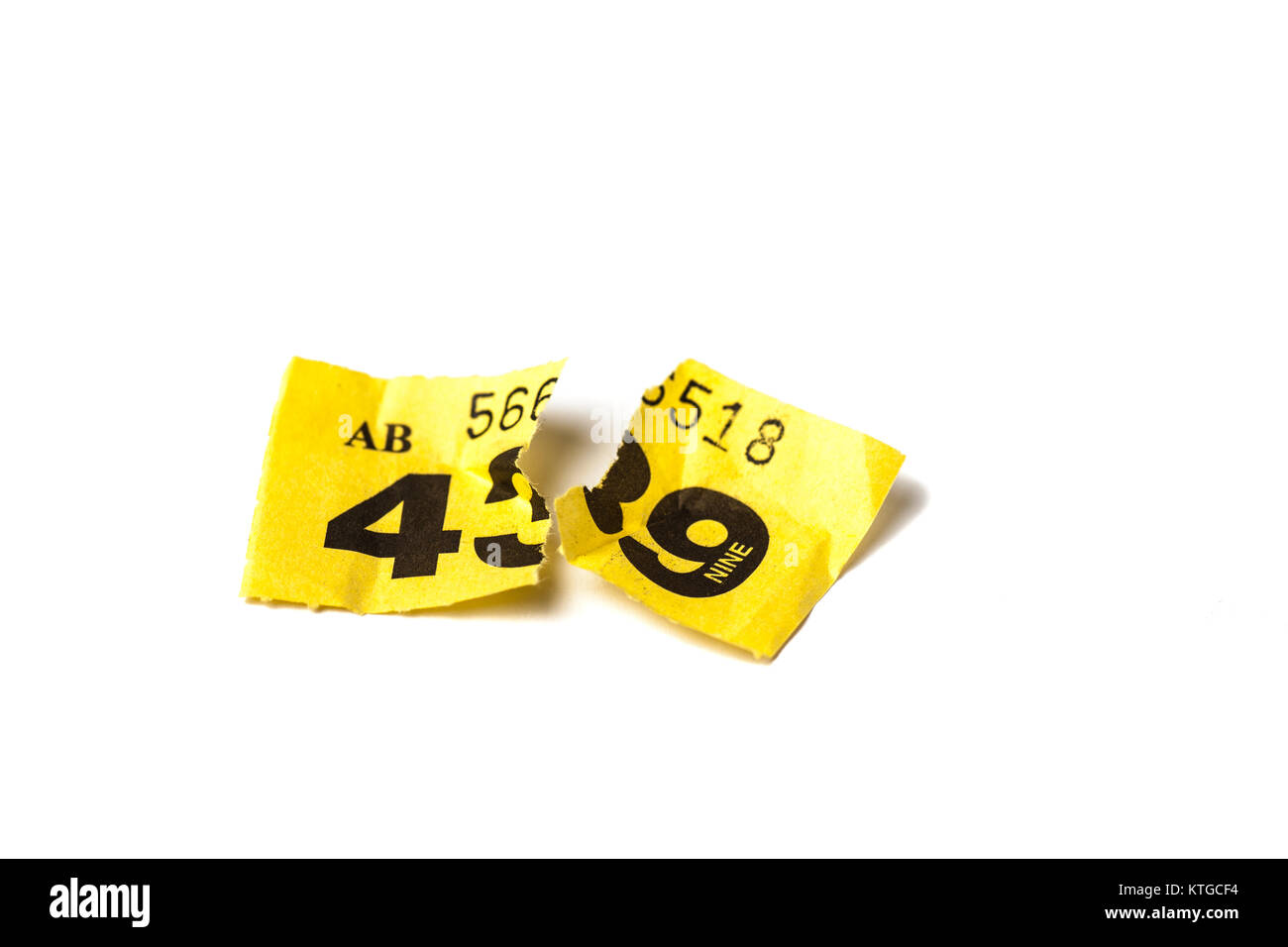 Torn Up Yellow raffle ticket. Losing number Stock Photo - Alamy