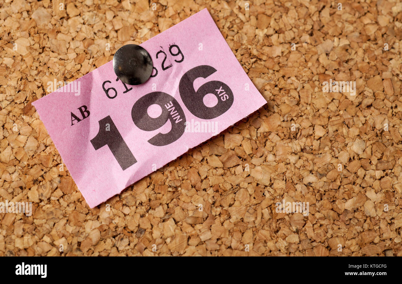 Pink Raffle ticket pinned onto a cork notice board Stock Photo - Alamy