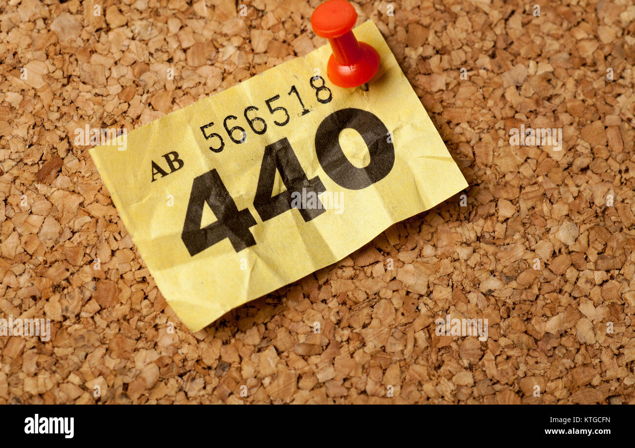 Yellow Raffle ticket pinned onto a cork notice board Stock Photo - Alamy