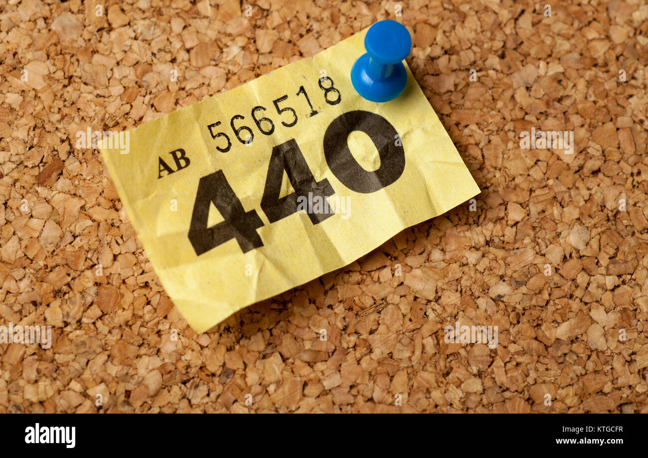 Yellow Raffle ticket pinned onto a cork notice board Stock Photo - Alamy