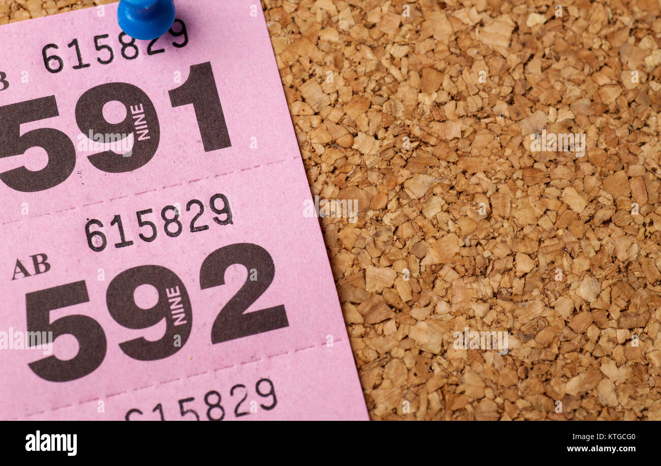 Strip of Pink Raffle tickets pinned onto a cork notice board Stock ...