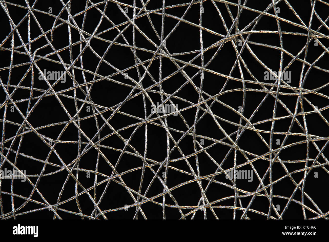 Chaotic weave of silver threads on black, abstract background Stock ...
