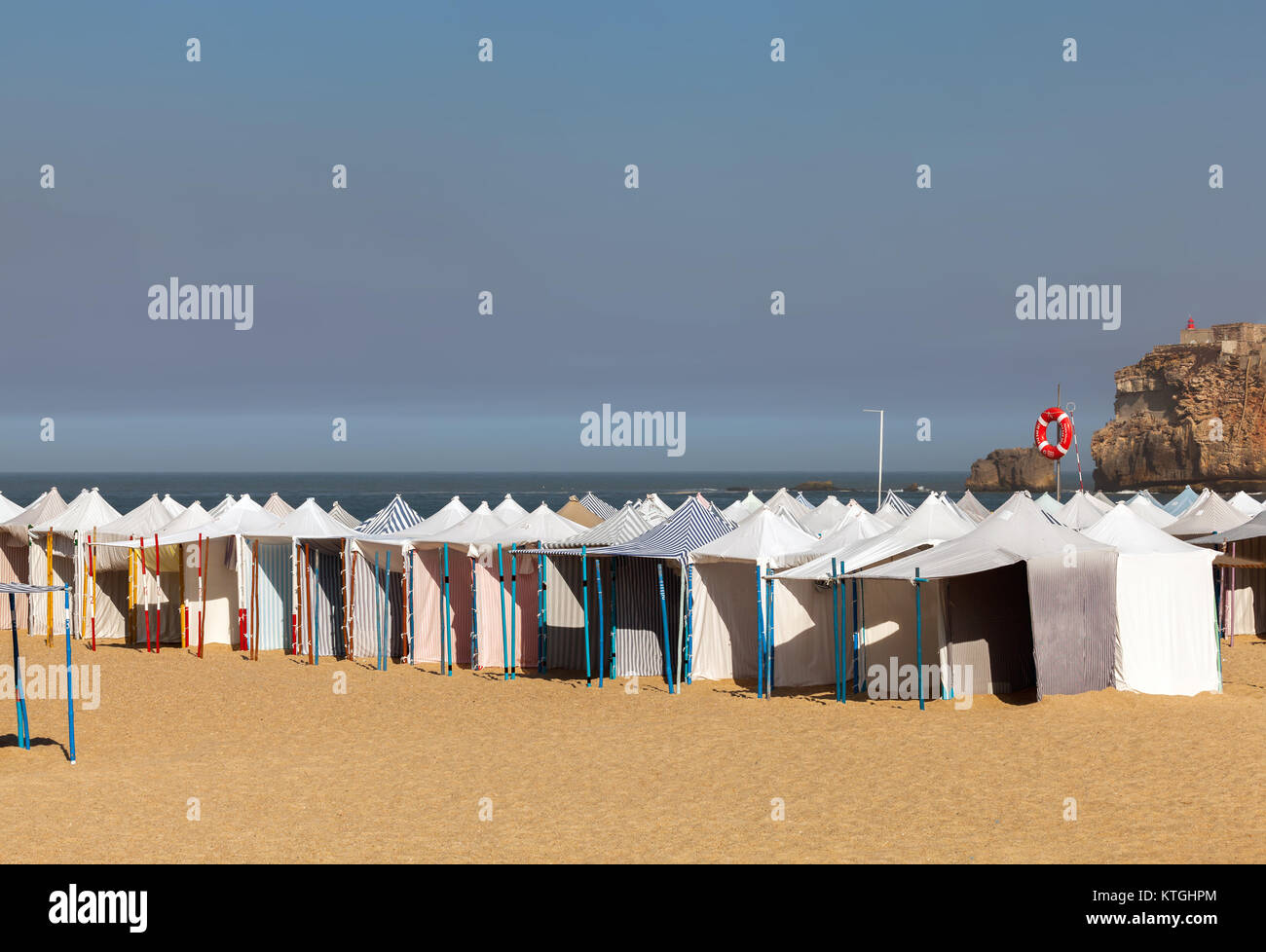Praia da Nazare beach in Nazare, Portugal, covered with the summertime ...