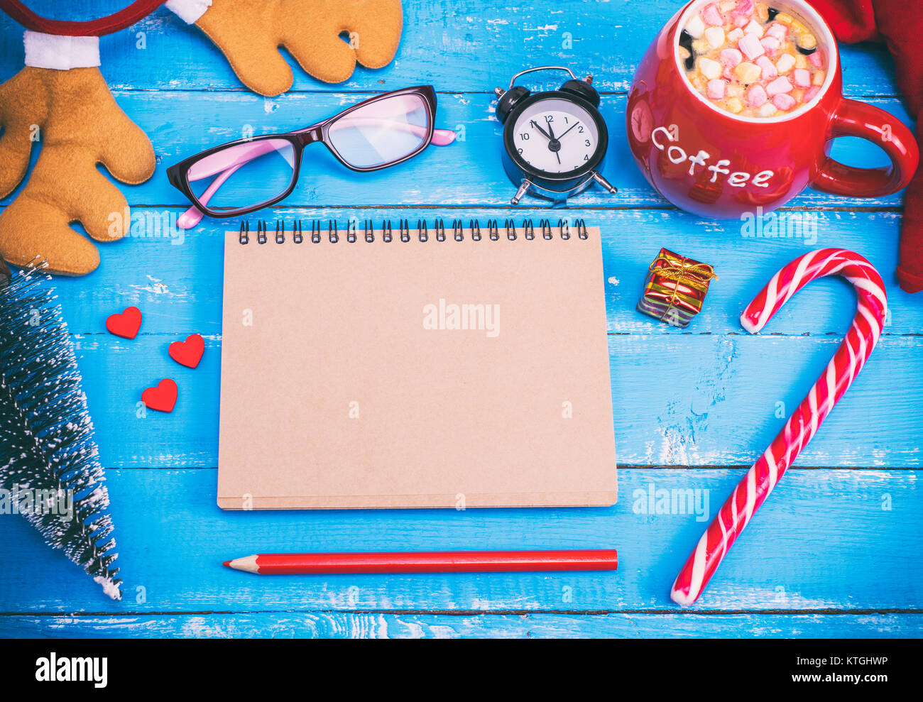 a notebook with empty brown pages and hot chocolate in a red ceramic ...