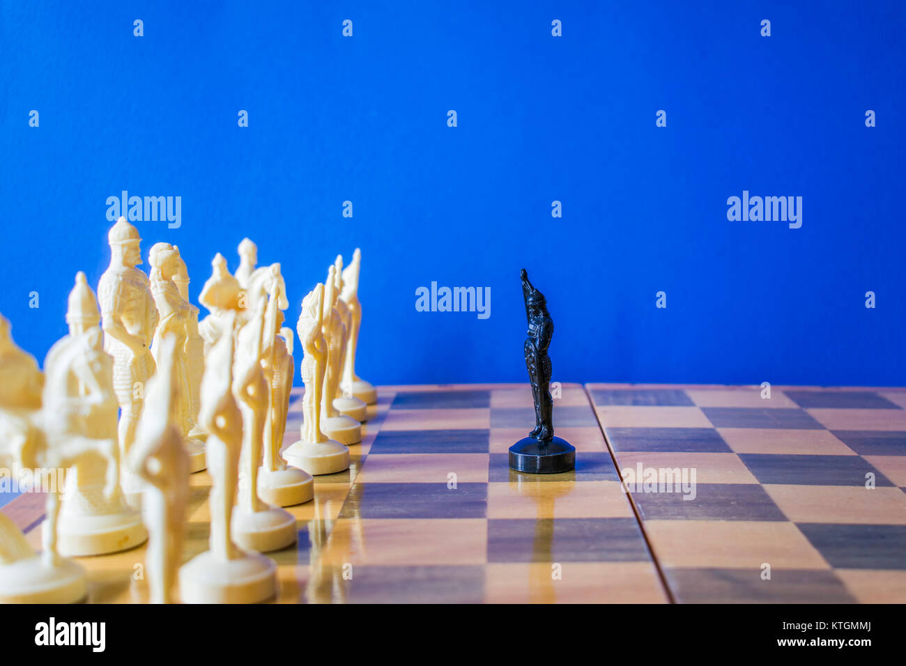 Chess on black background. A black pawn is facing an enemy army Stock ...