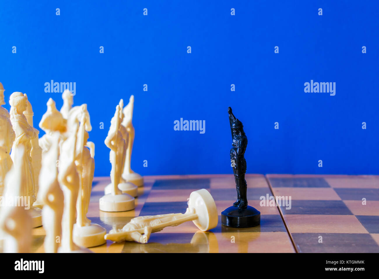 Chess on black background. A black pawn is facing an enemy army Stock ...