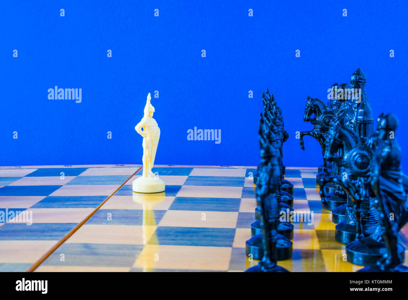 Chess on black background. White pawn is facing the enemy army Stock ...