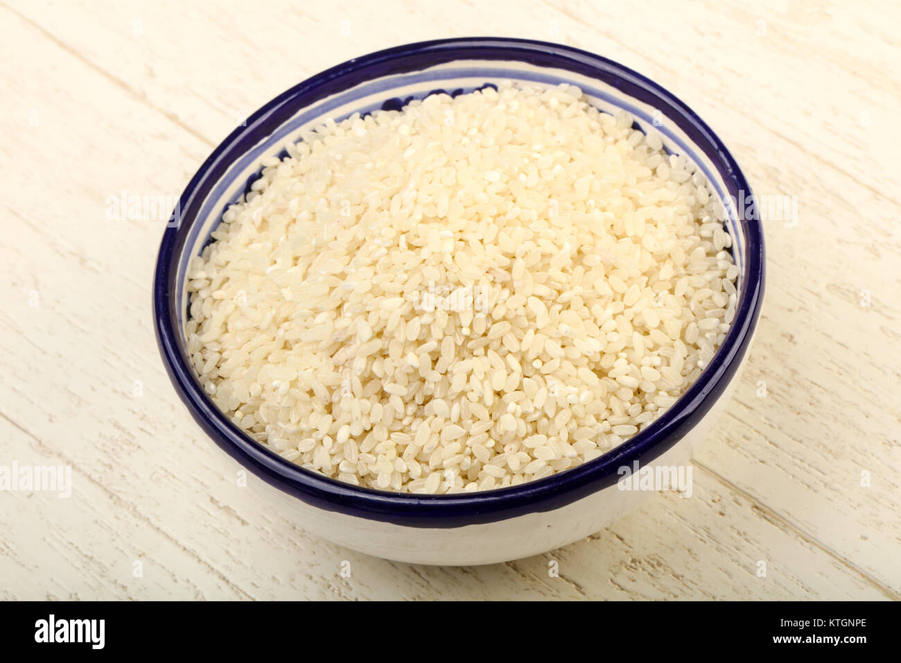 Raw rice heap in the bowl - ready for cooking Stock Photo - Alamy