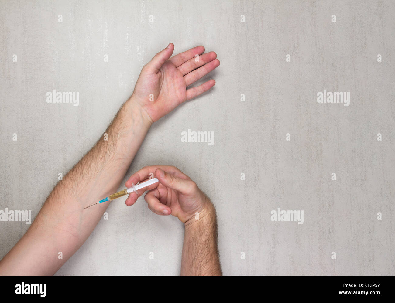 hands of man making himself an injection of disposable medical syringe ...