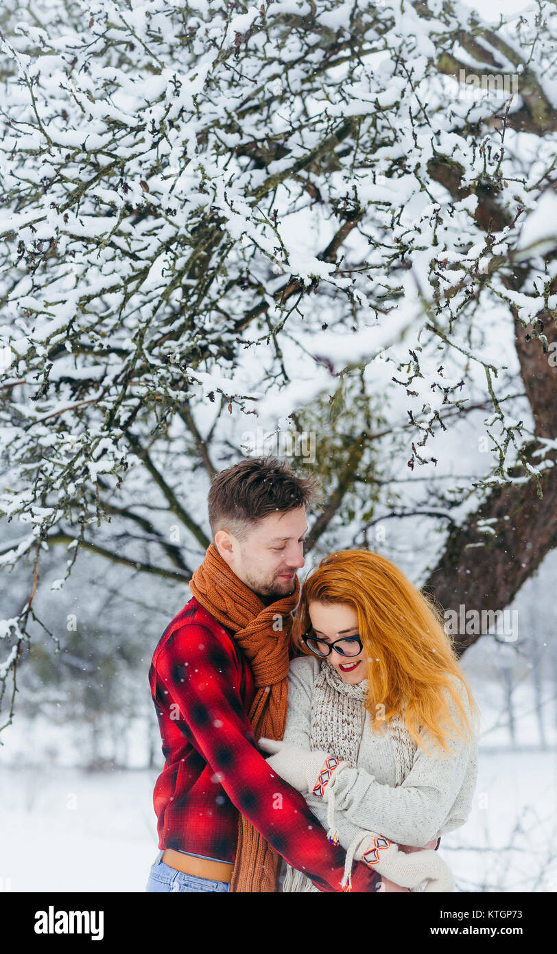 Half-length vertical portrait of the cheerful beautiful couple hugging ...