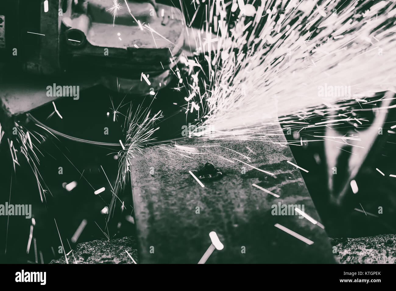 sparks flying from under the rotating disc grinder when cleaning steel ...