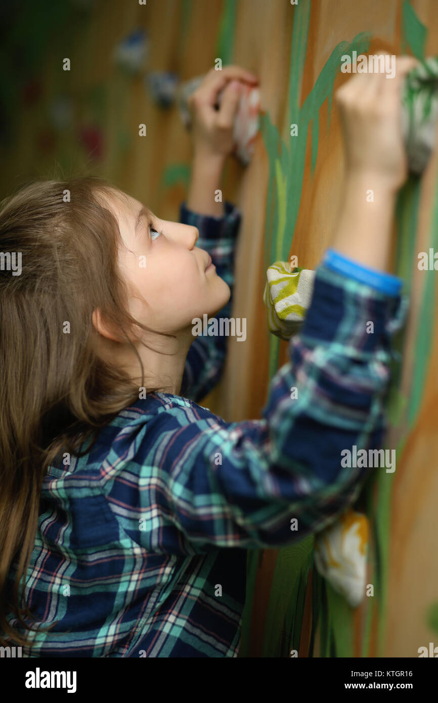 Child in the children's room. The kid is sitting on the windowsill at ...