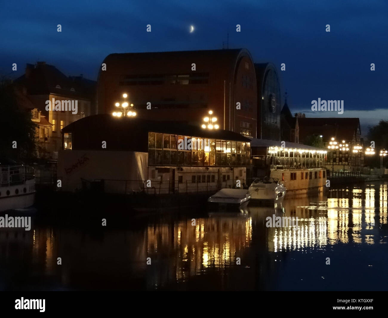 A night-time image of a riverside area in Brdy, Poland, capturing the ...