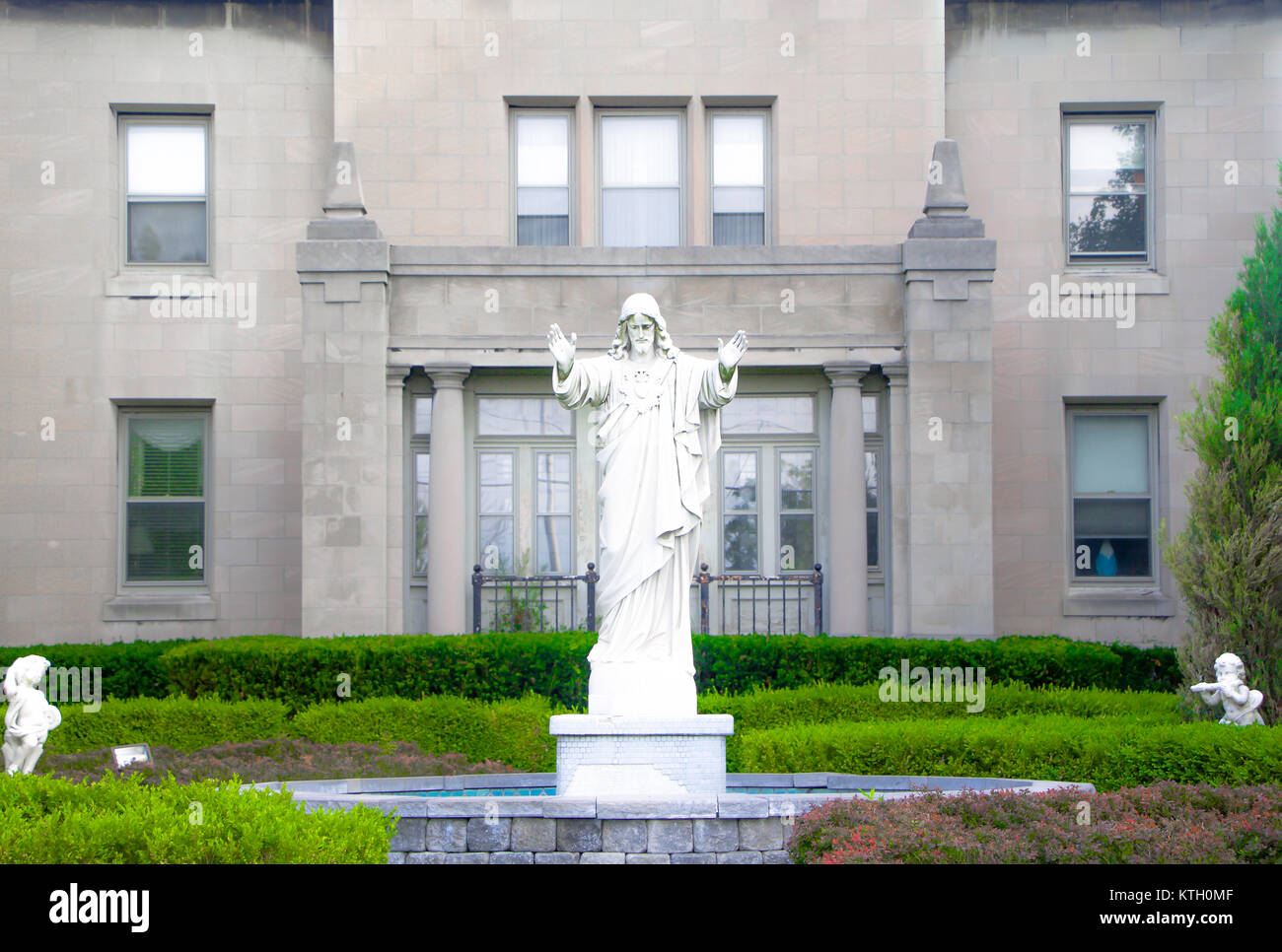 Exterior daytime marble statue of Jesus Christ in courtyard of Church ...