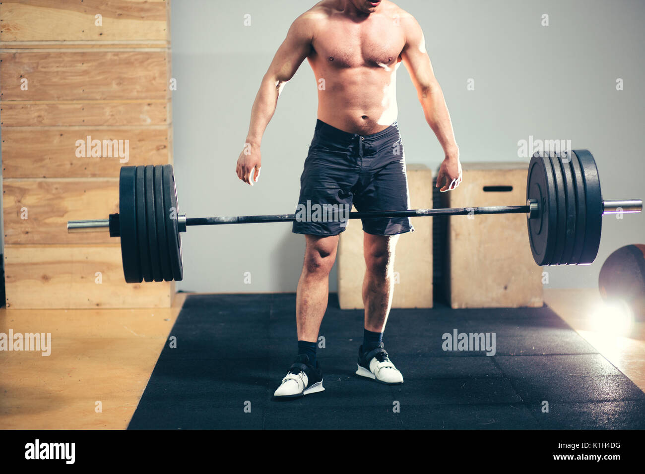 Bodybuilder drops heavy barbell weights during training Stock Photo - Alamy
