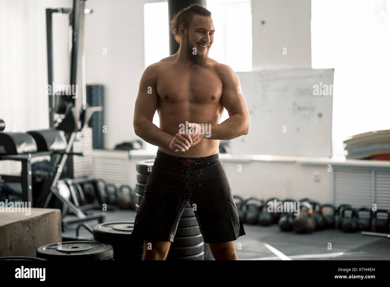 smiling man in gym clapping hands Stock Photo - Alamy