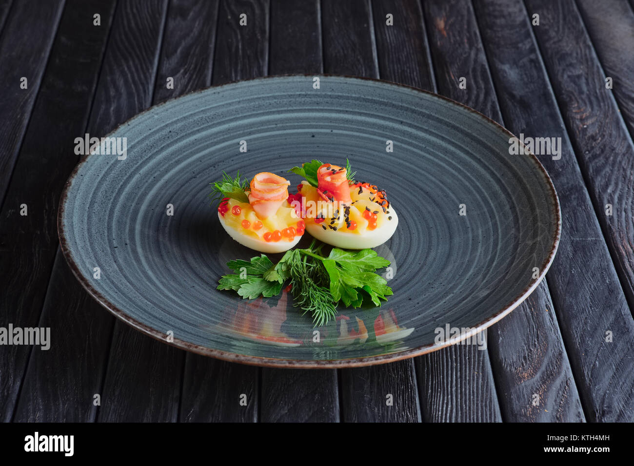Appetizer for reception. Egg with ham and caviar Stock Photo - Alamy