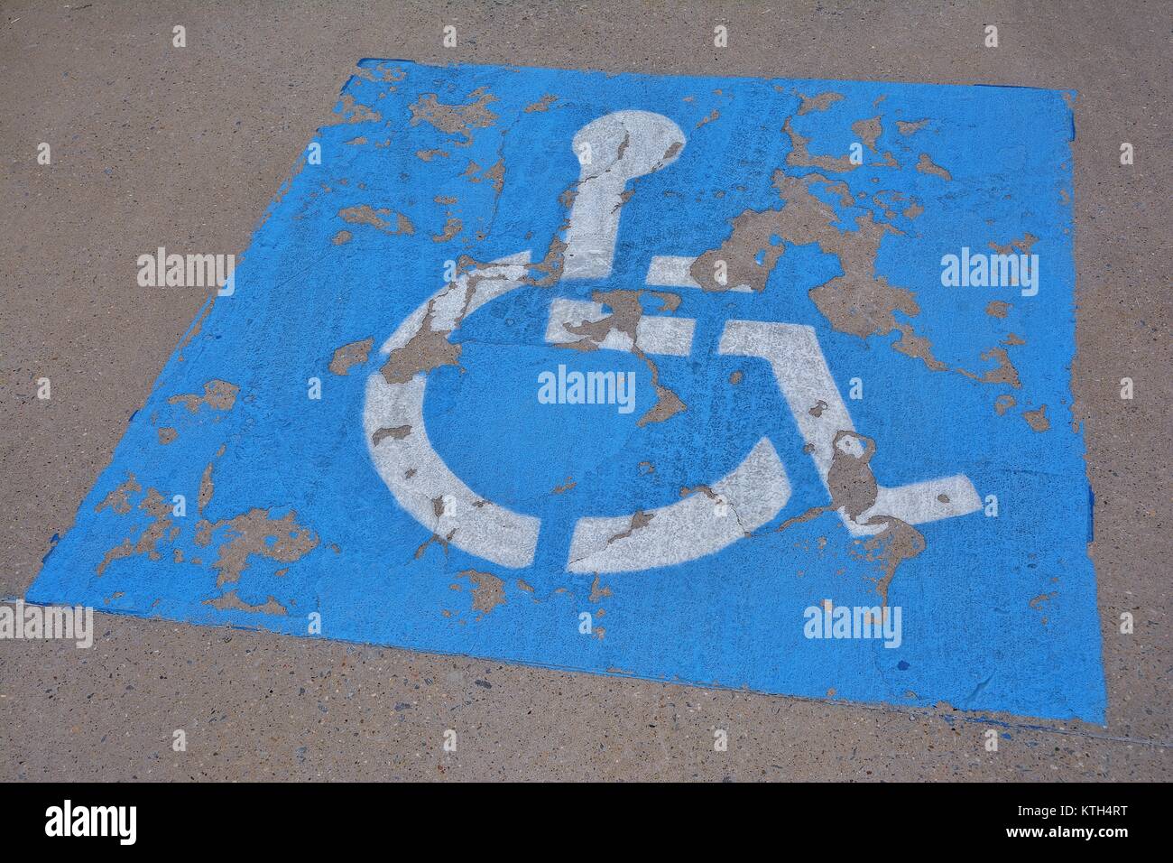 Disabled blue parking sign painted on dark asphalt Stock Photo - Alamy