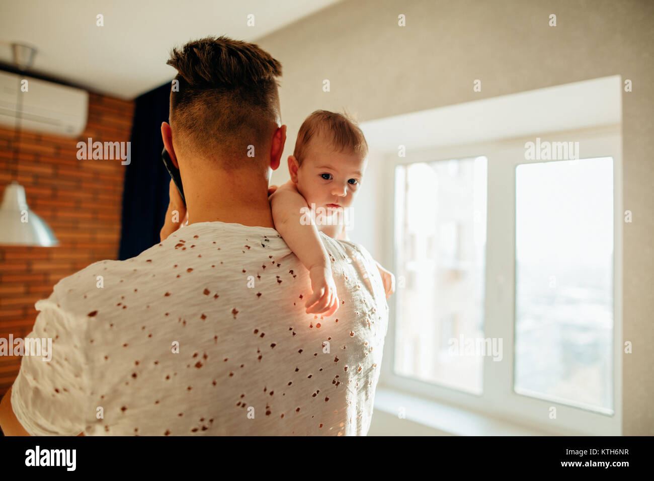 young father holding his newborn baby son Stock Photo - Alamy