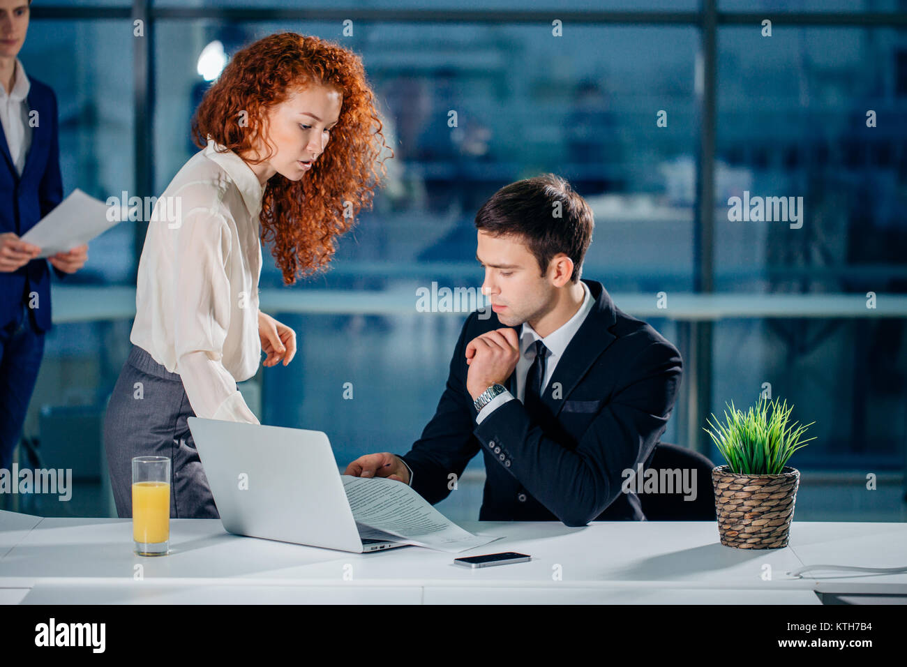 Worried man receiving notification from colleague in her workplace at ...