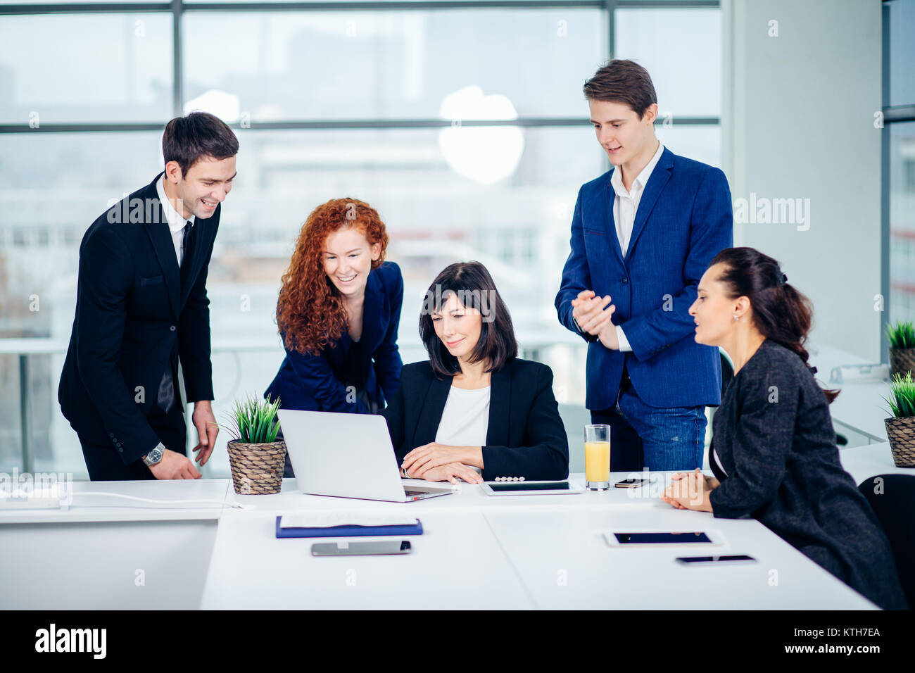 male and female business people around laptop computer in office Stock ...