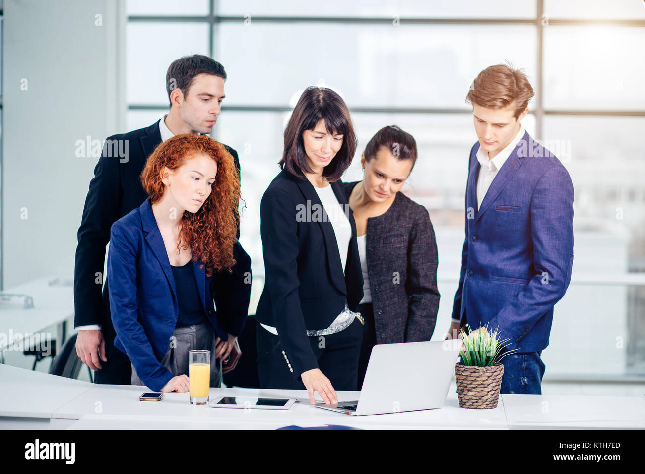 male and female business people around laptop computer in office Stock ...