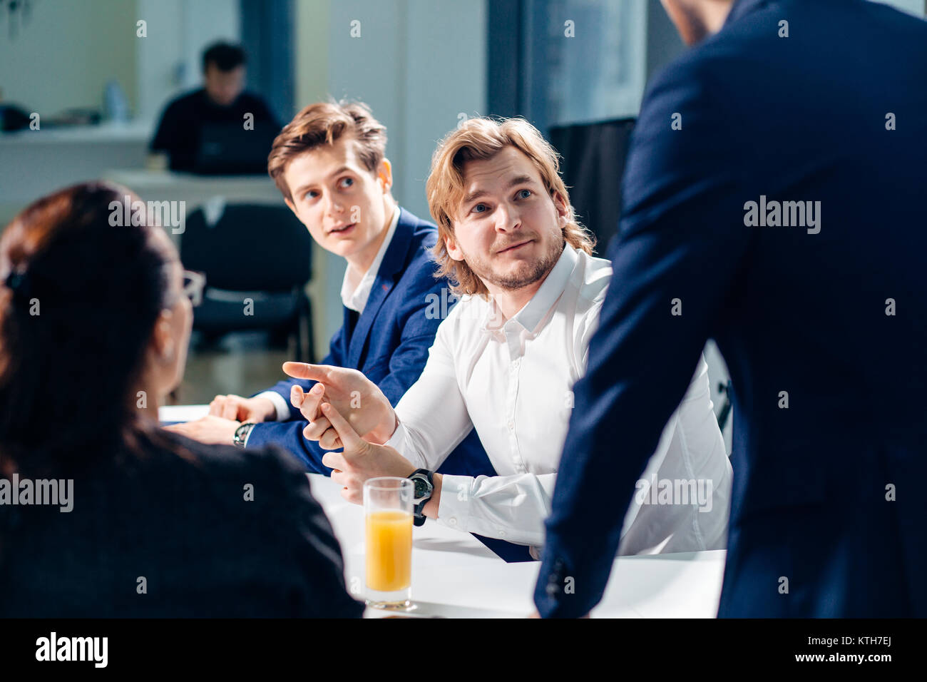 Businessman presenting to colleagues at meeting Stock Photo - Alamy
