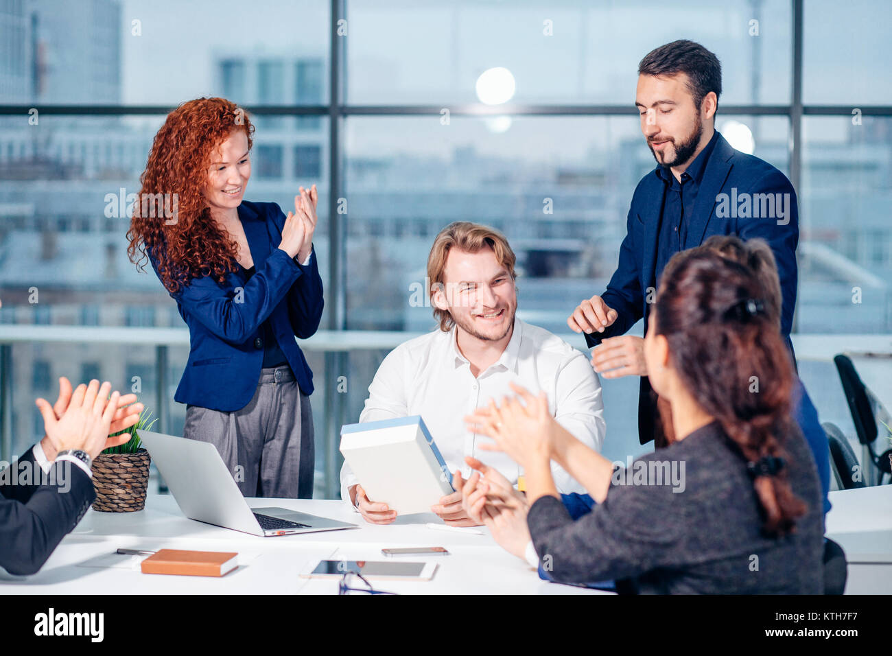 Colleagues celebrating bday party in office smiling giving presents to ...