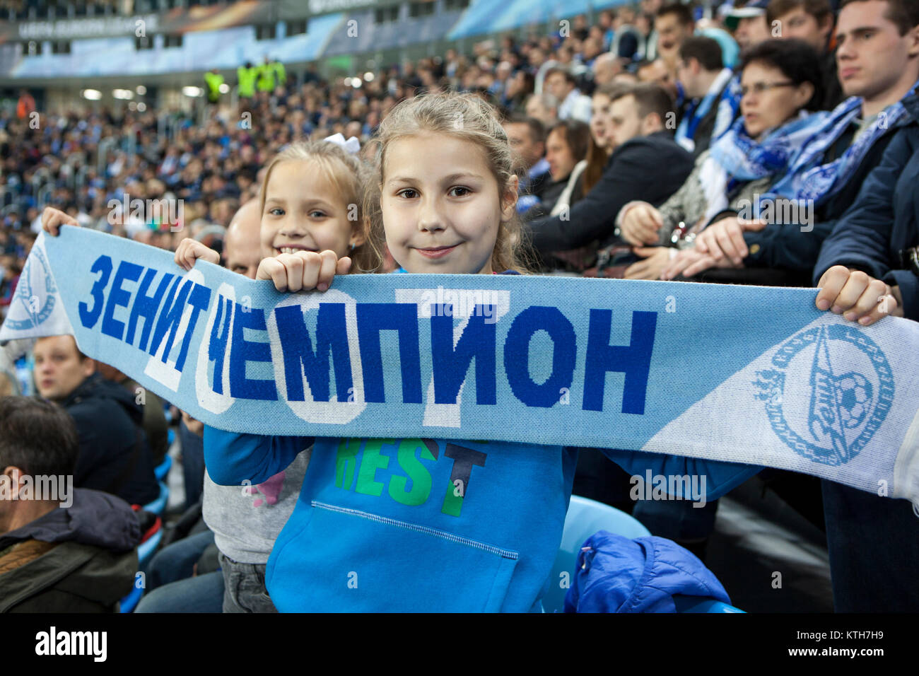 Two young girls fans with white and blue scarf with inscription: Zenit ...