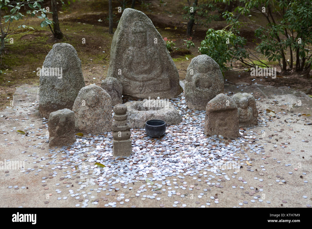 Stone Idols with lot of coins around. Golden Pavilion or Rokuon-ji, or ...