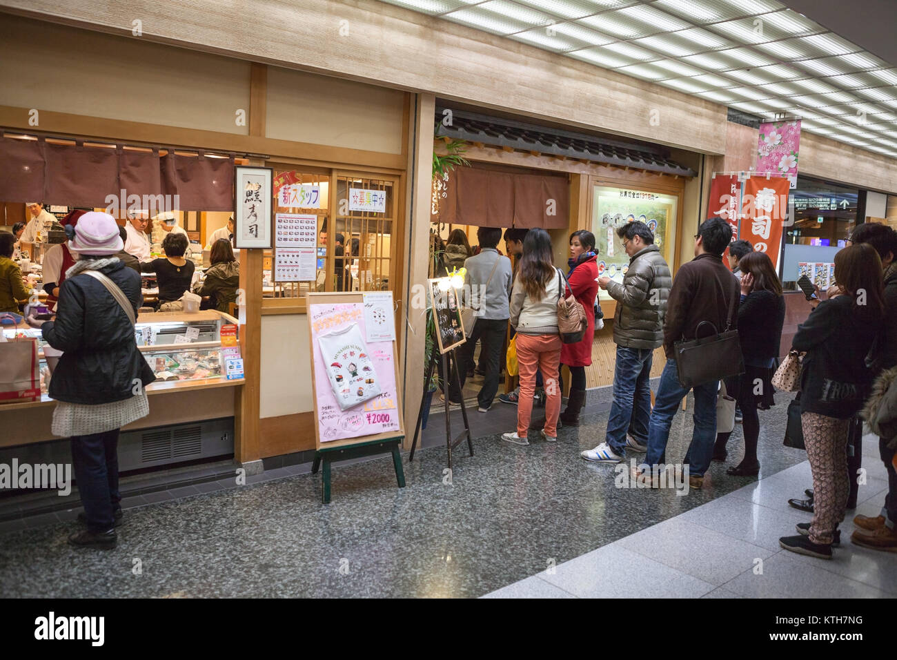 JAPAN, TOKYO-CIRCA APR, 2013: Asian visitors stand in queue to enter ...