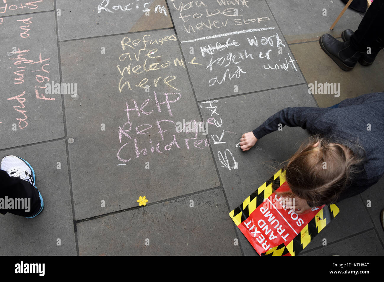 “Refugees are welcome here” and “Help refugee children” messages are ...