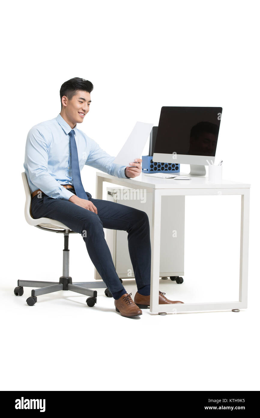 Young businessman reading files in office Stock Photo - Alamy