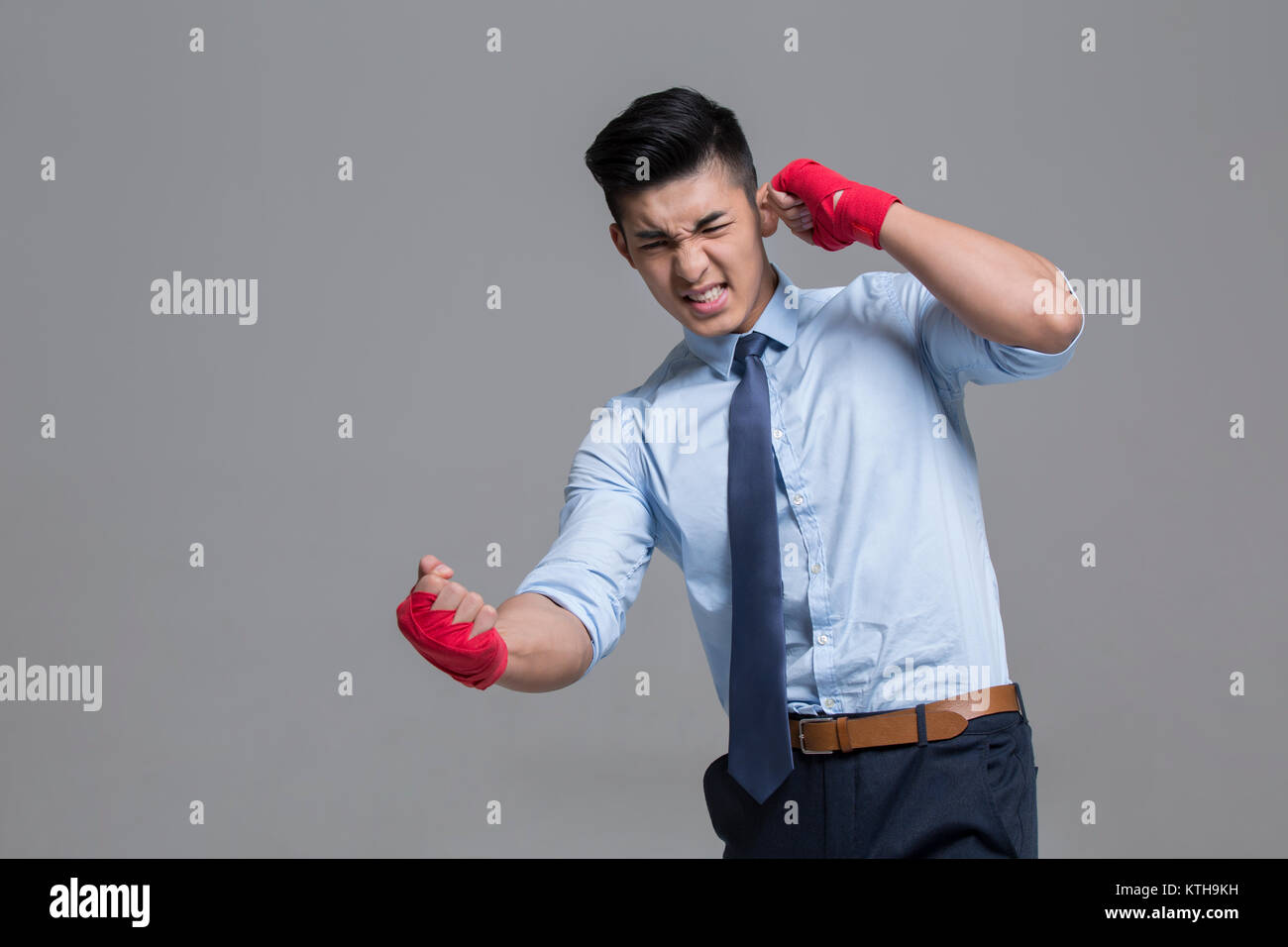 Young businessman punching Stock Photo - Alamy
