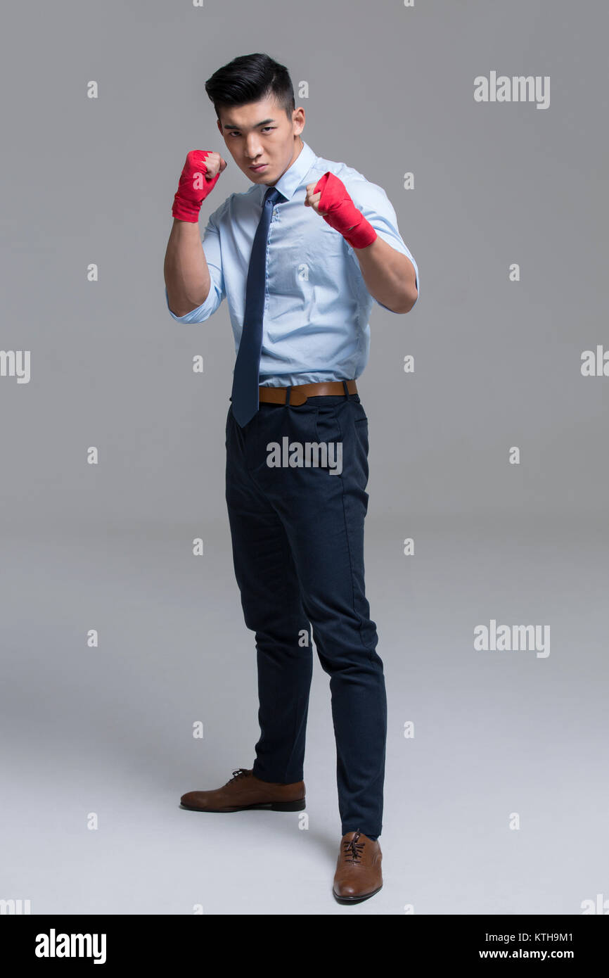 Young businessman boxing with raised fists Stock Photo - Alamy