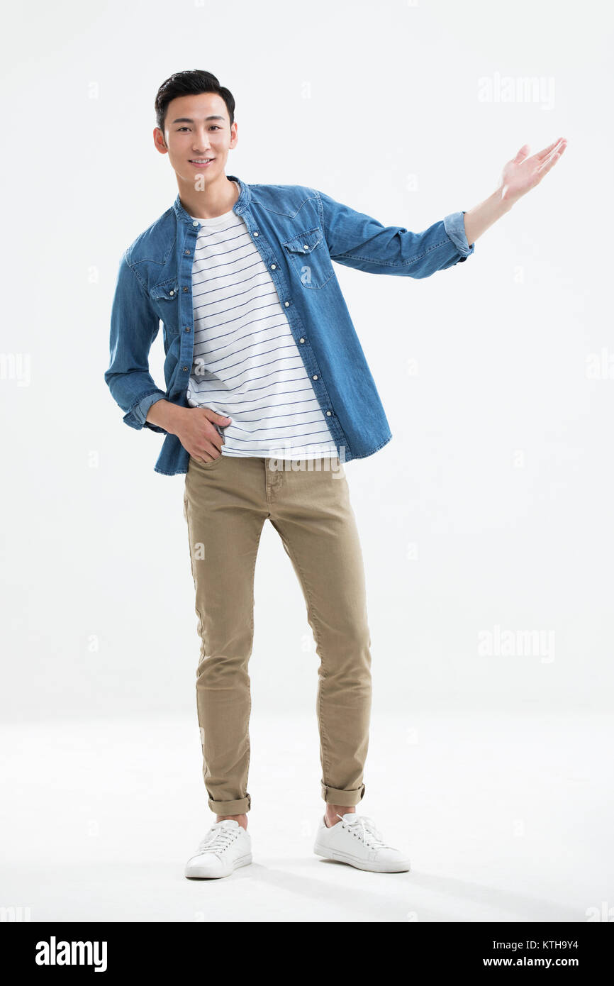 Cheerful young man greeting Stock Photo - Alamy