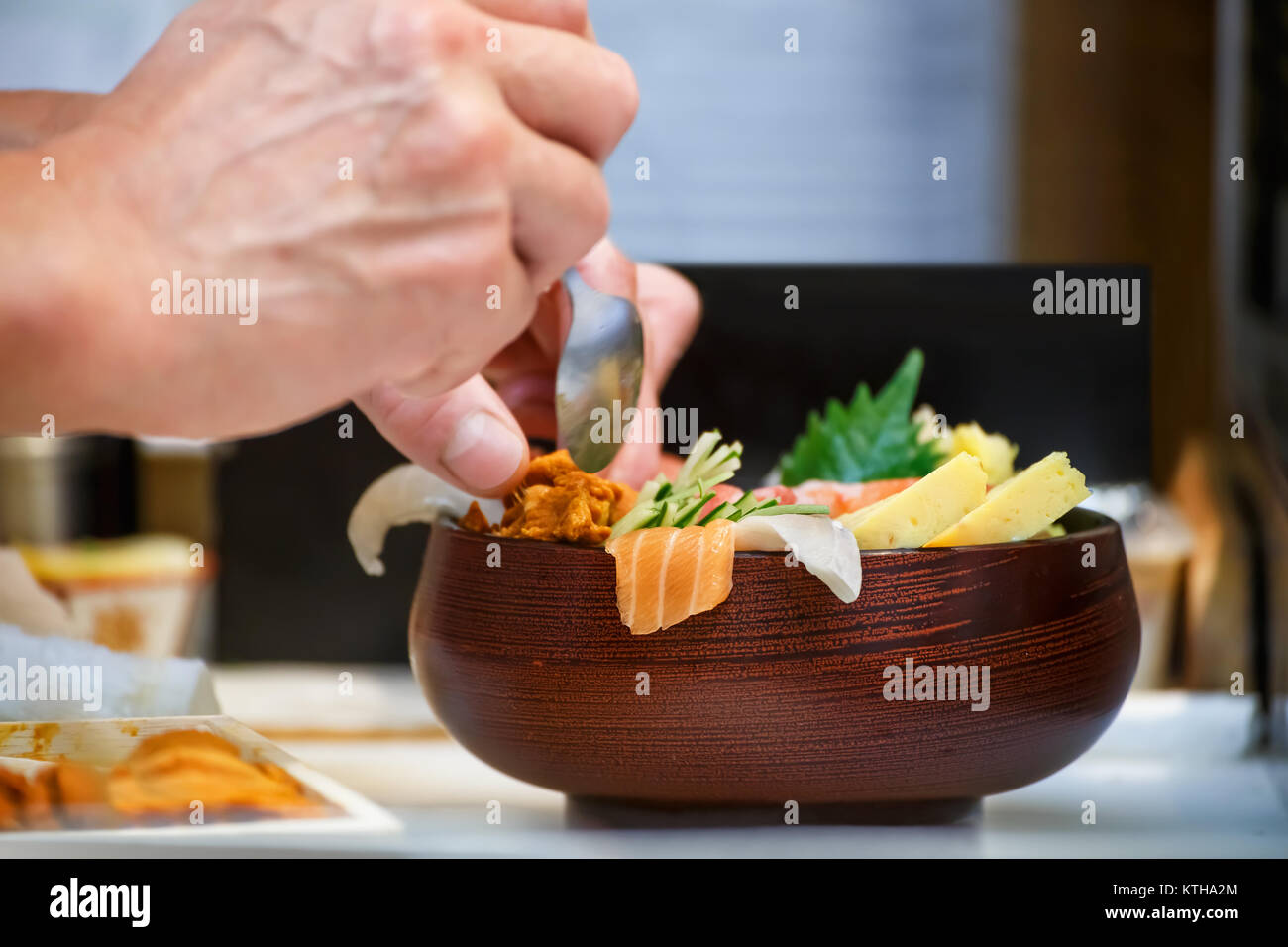 Closeup of a bowl of Sashimi with hands of Japanese chef TOKYO, JAPAN ...