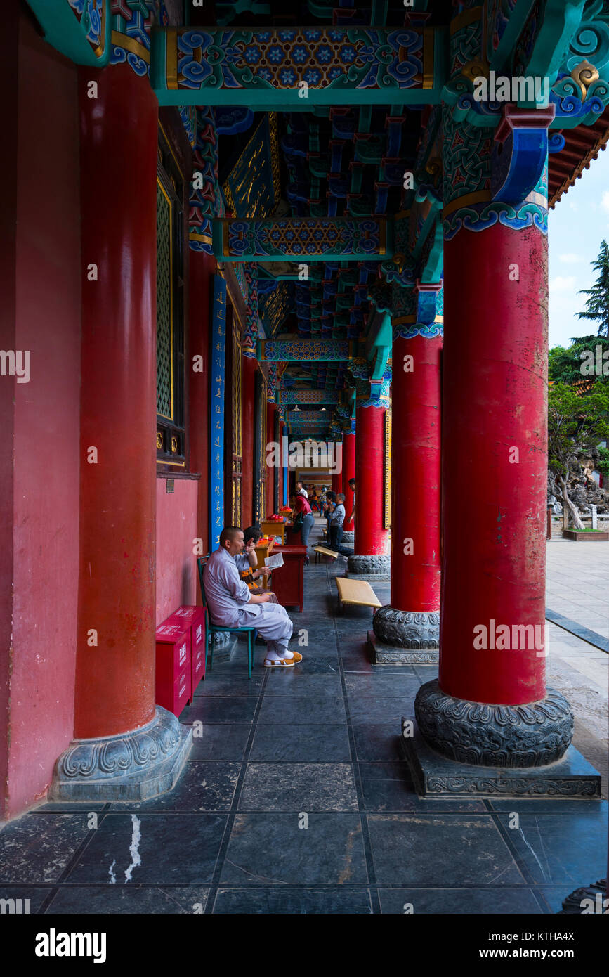 People doing a traditional praying before a Buddhist statue in a ...