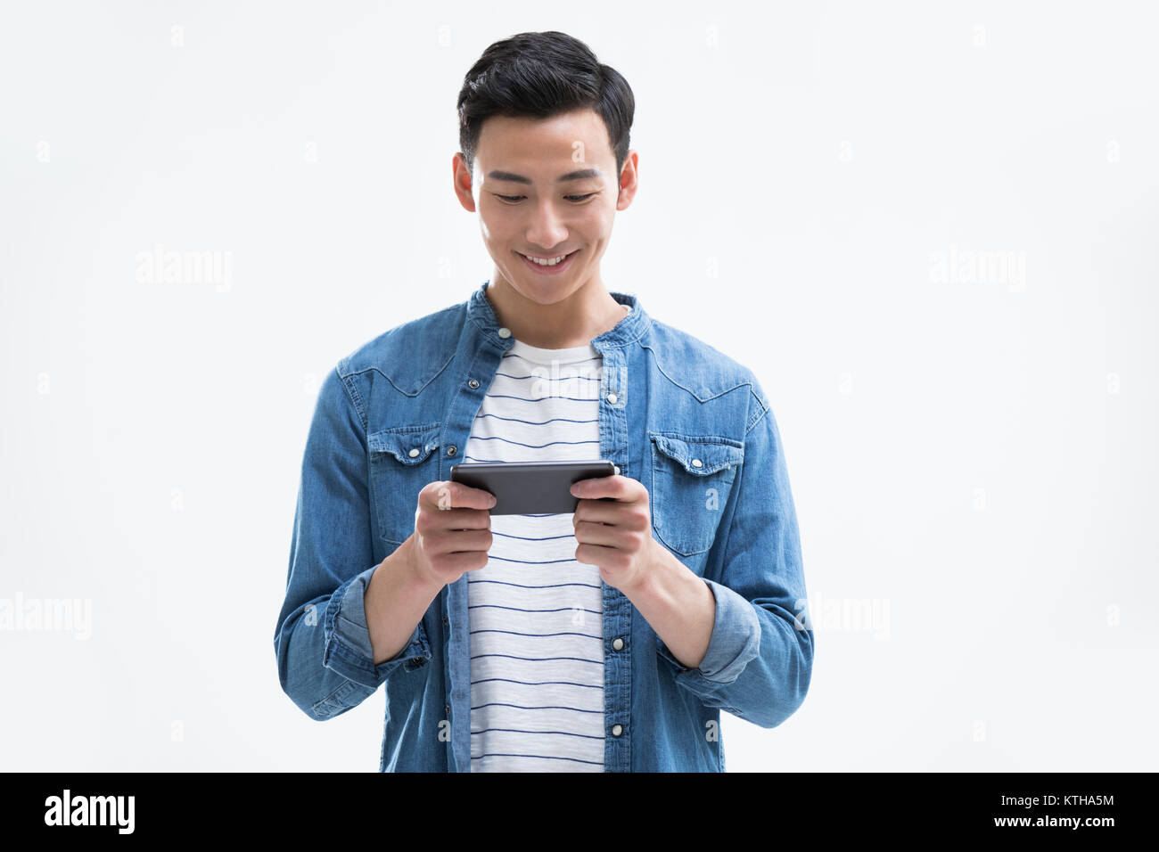 Young man playing mobile games Stock Photo - Alamy
